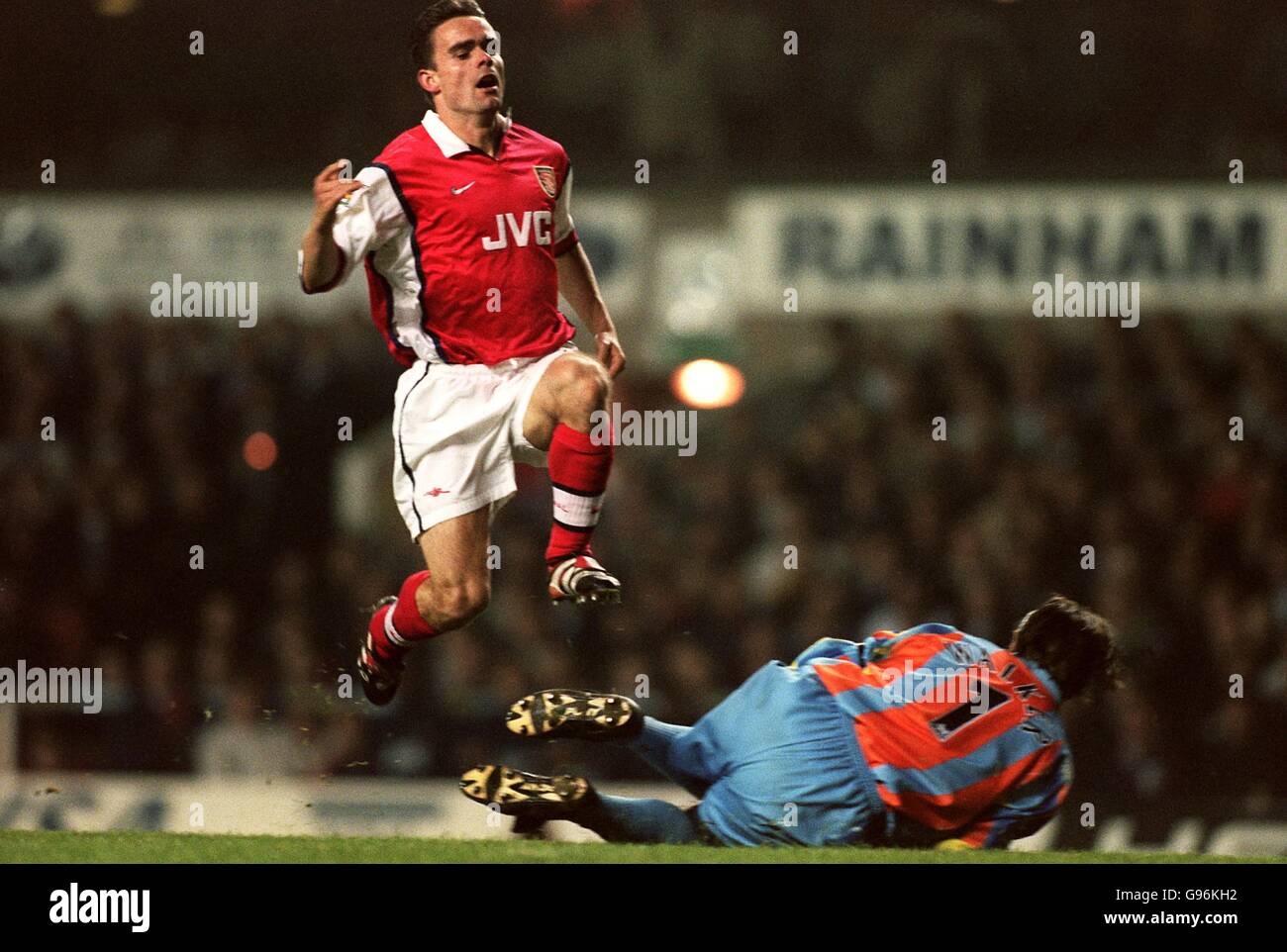 Tottenham Hotspur goalkeeper Ian Walker (right) saves from Arsenal's ...