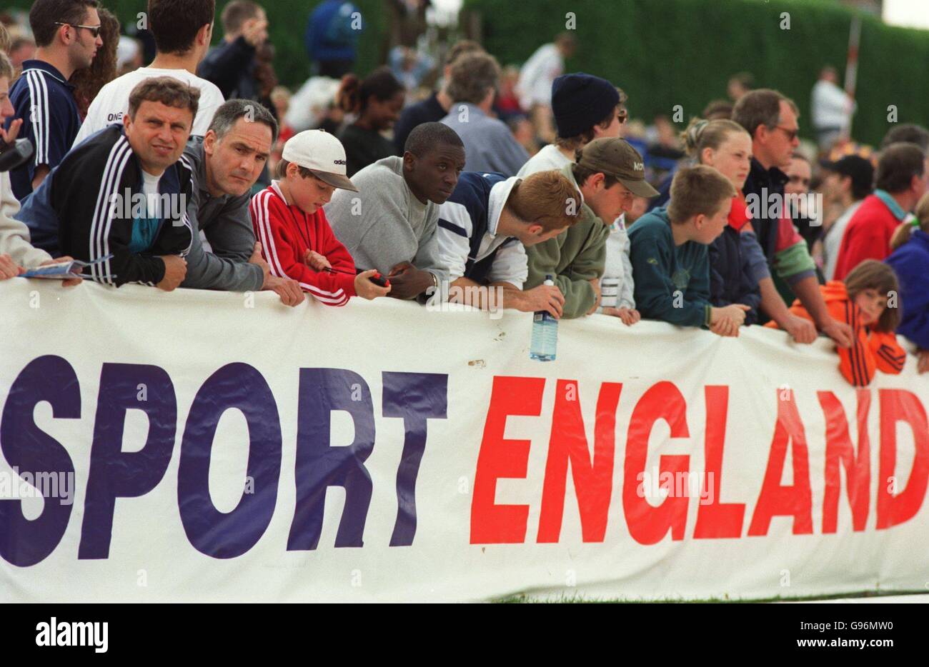 Spectators lean against sport england banner watch competition hi-res ...