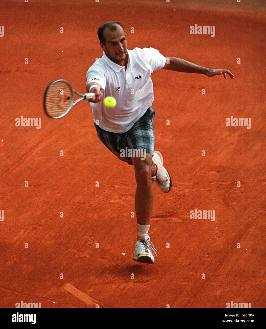 Tennis - French Open - Quarter Finals. Andrei Medvedev lunges for the ...