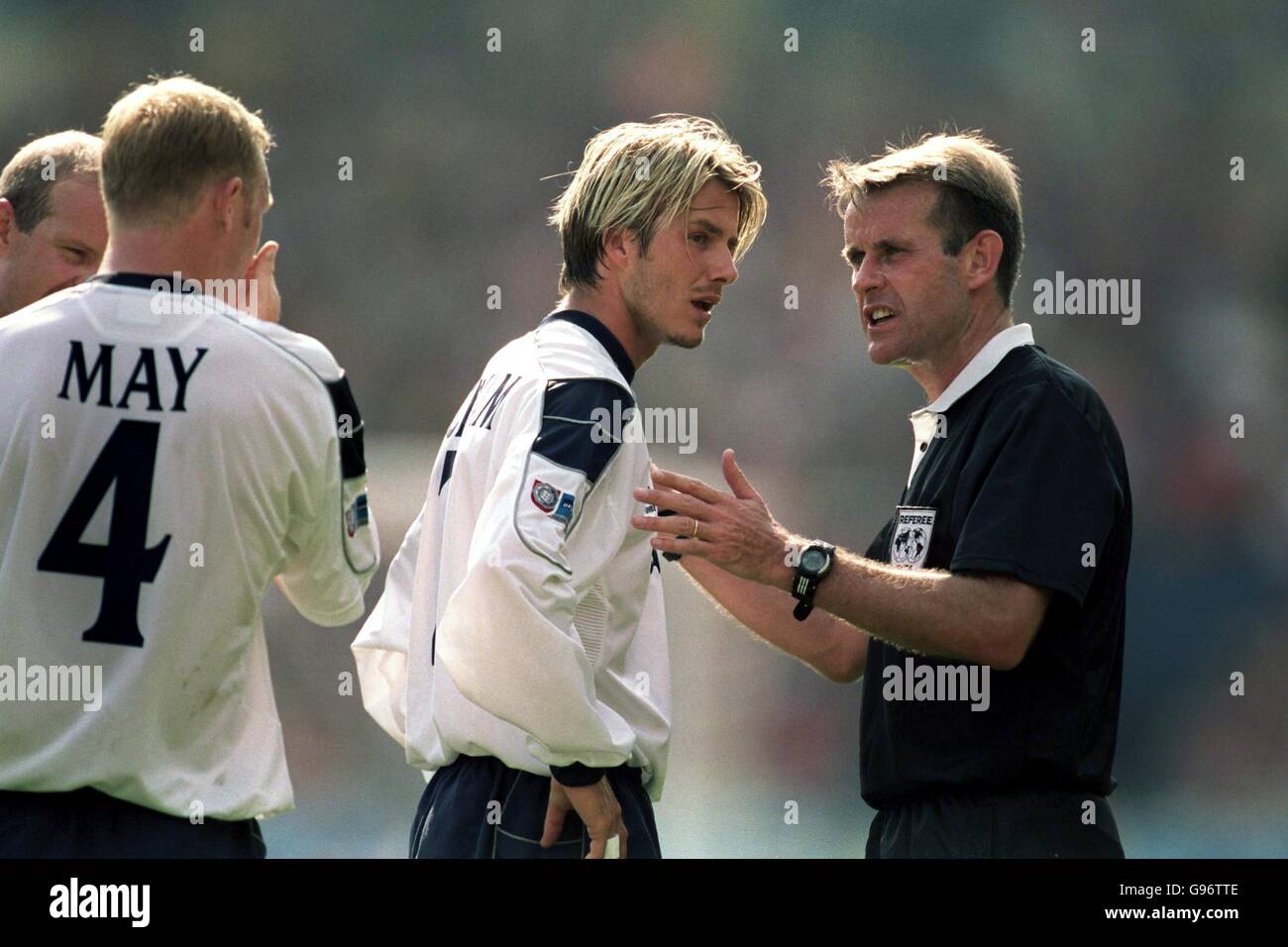 Referee Graham Barber (right) warns Manchester United's David Beckham ...