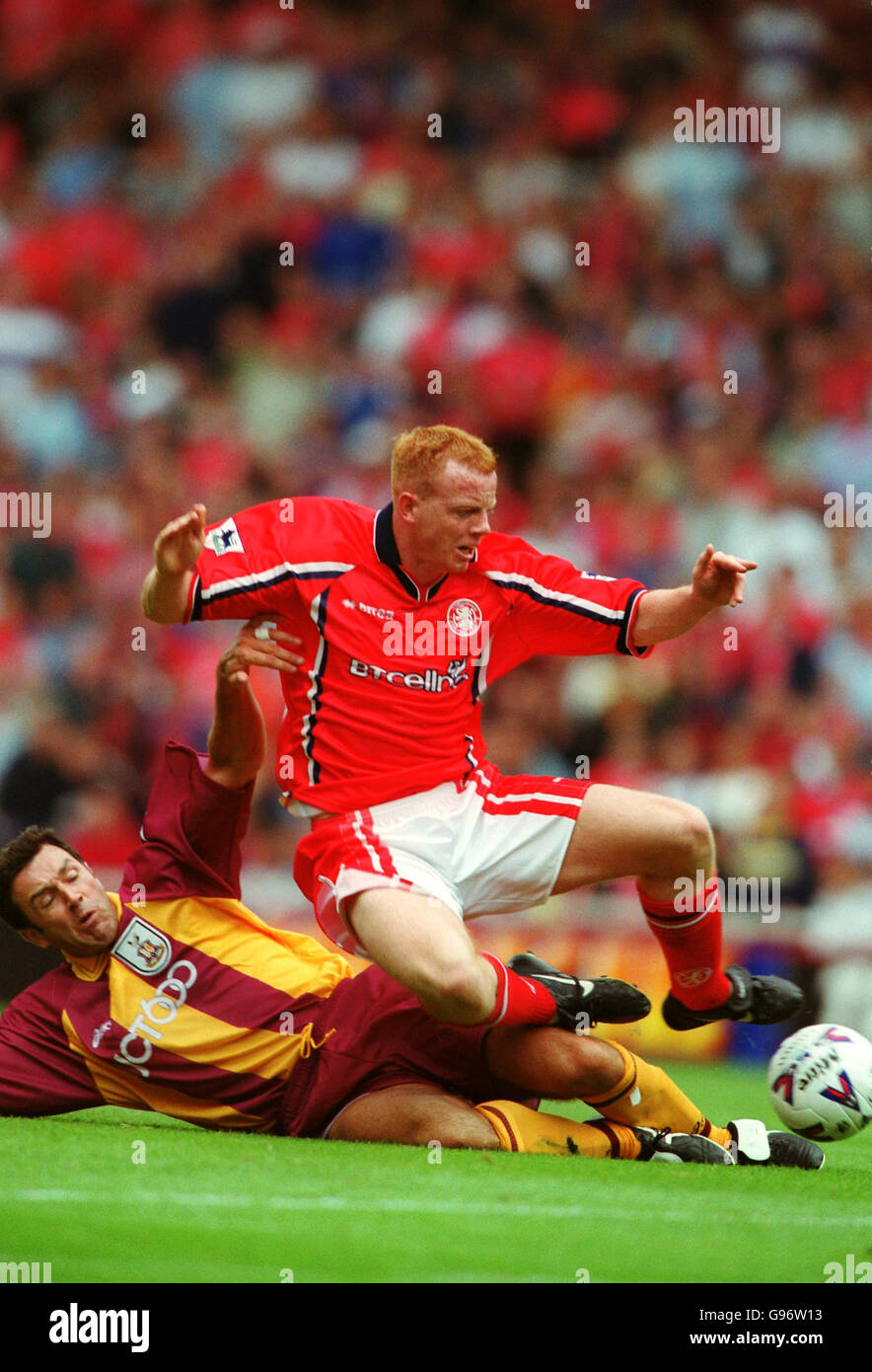 L-R; Bradford City's John Dreyer slides in to challenge Middlesbrough's ...