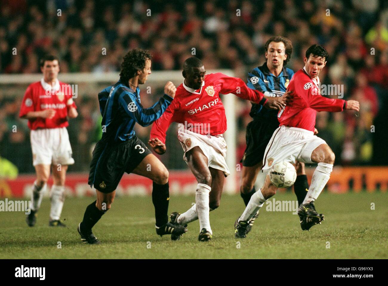 Andy Cole of Manchester United (second left) takes on Francesco ...