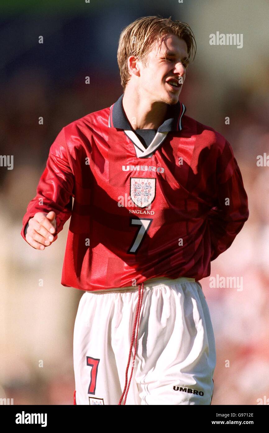 England's David Beckham sustains an injury to his back side and has to ...