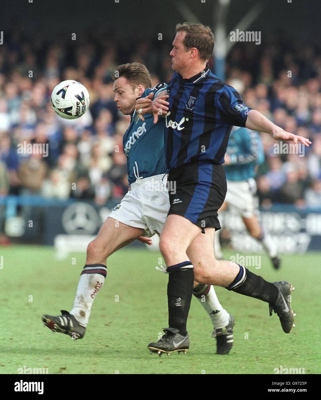 Manchester City's Paul Dickov & Gillingham's Guy Butters fight for the ...