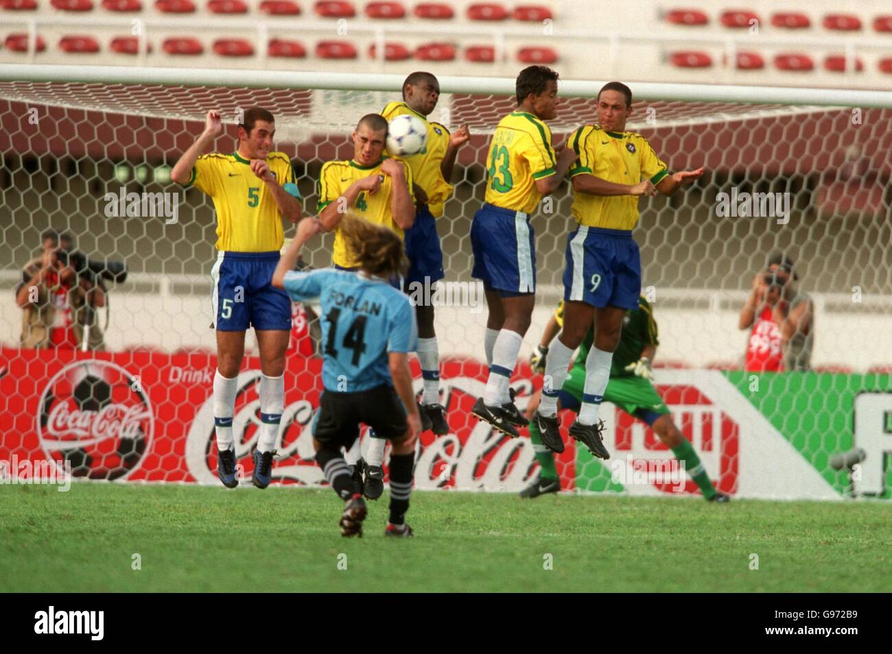 The Brazilian defence wall try and block Uruguay's Diego Forlan taking ...