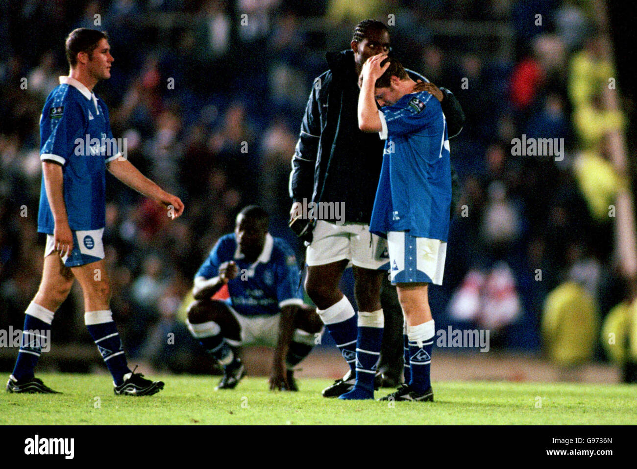 Birmingham's Chris Holland is consoled by teammates after his penalty ...