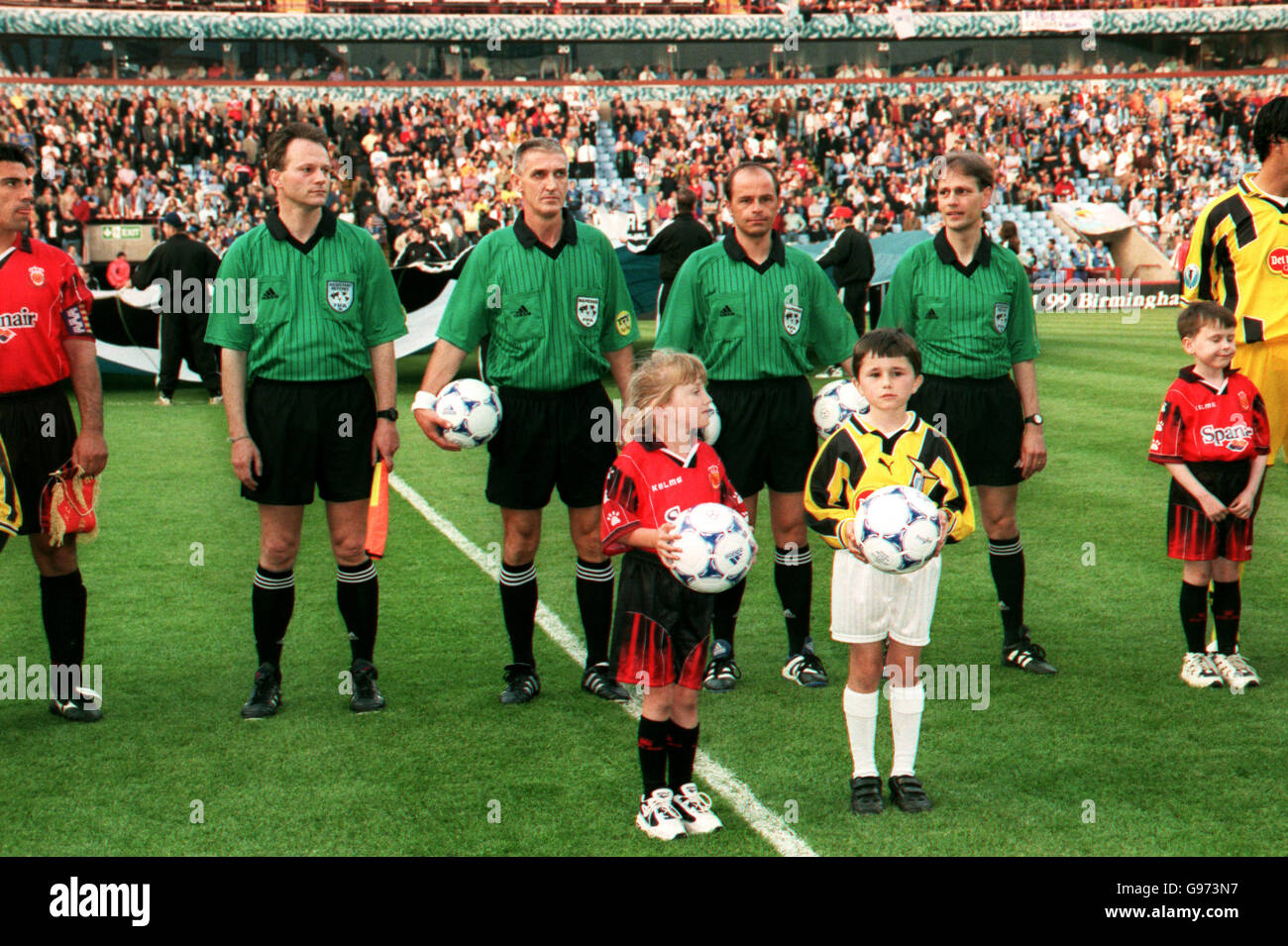 The four officials line up with the mascots for the two teams Stock ...