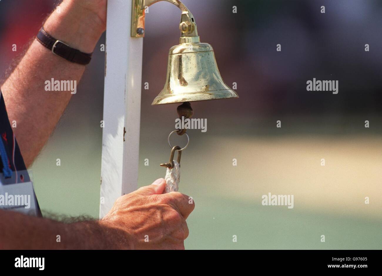 The bell is run as the athletes start their final lap Stock Photo - Alamy