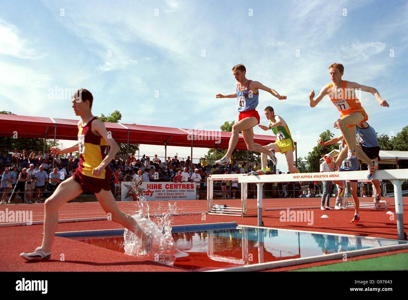 Andrew Franklin from Surrey (right) leaps the water jump on his way to ...
