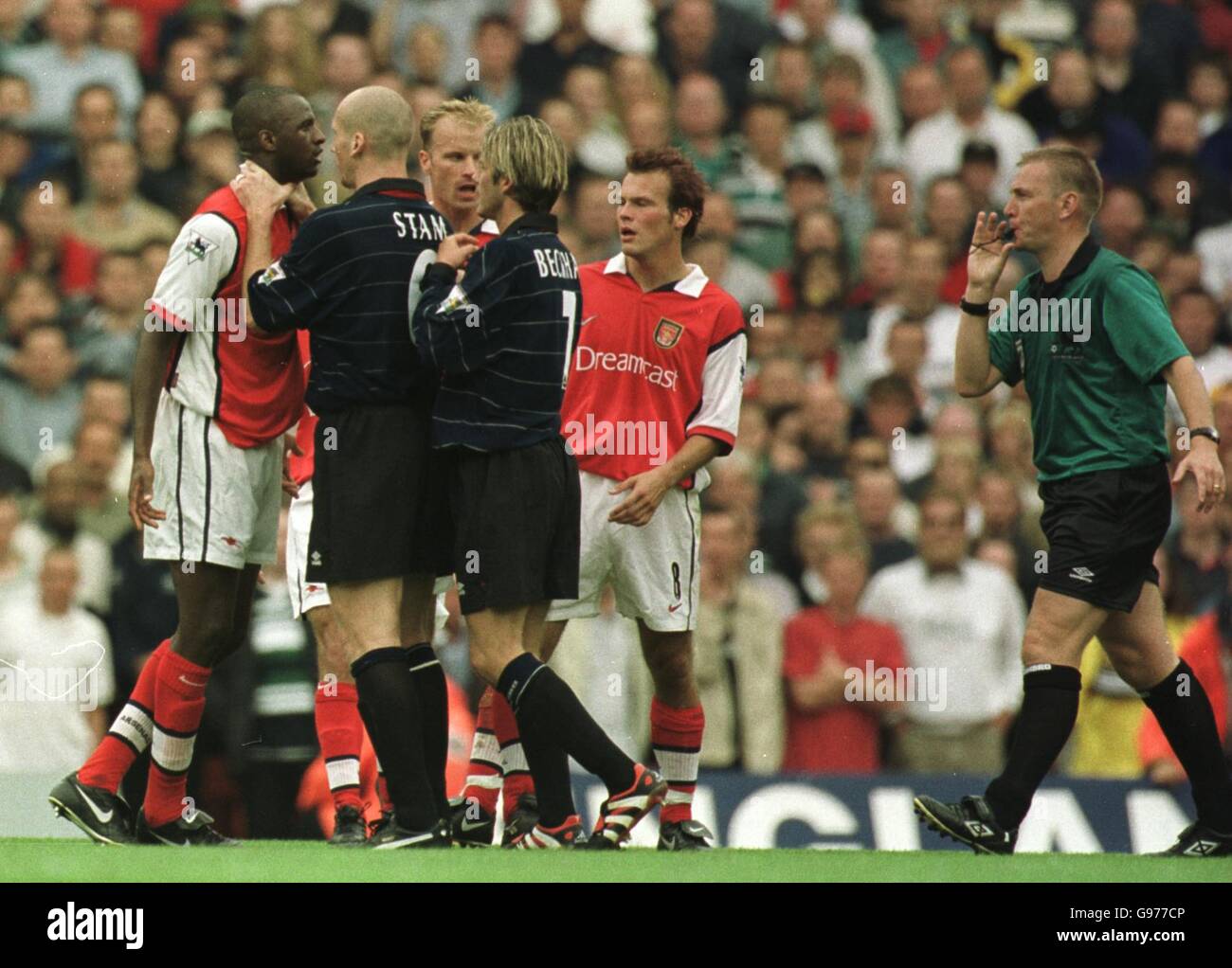 L-R; Arsenal's Patrick Vieira is strangled by Manchester United's Jaap ...