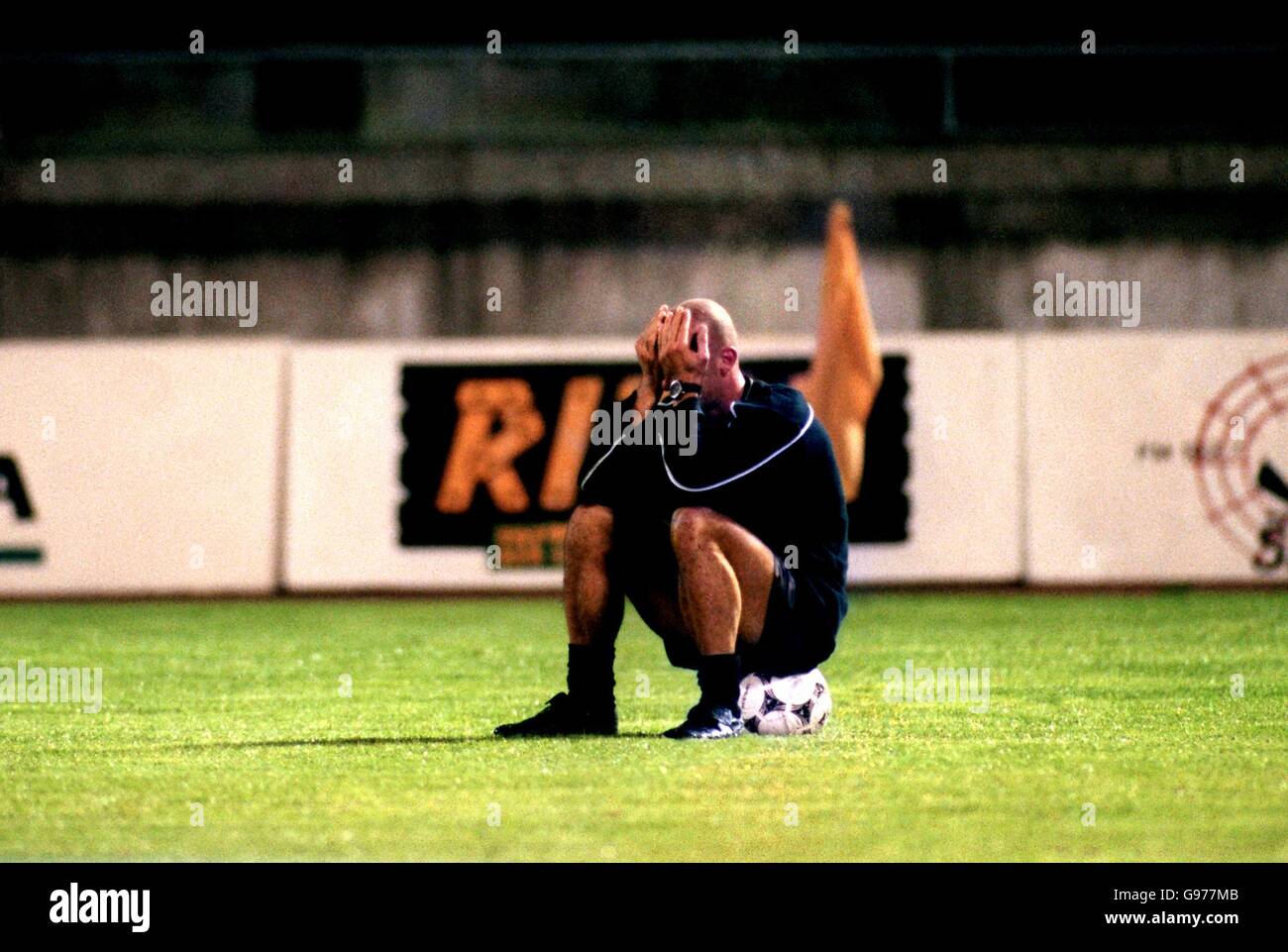 Coach knackered tired dejection head in hands football hi-res stock ...