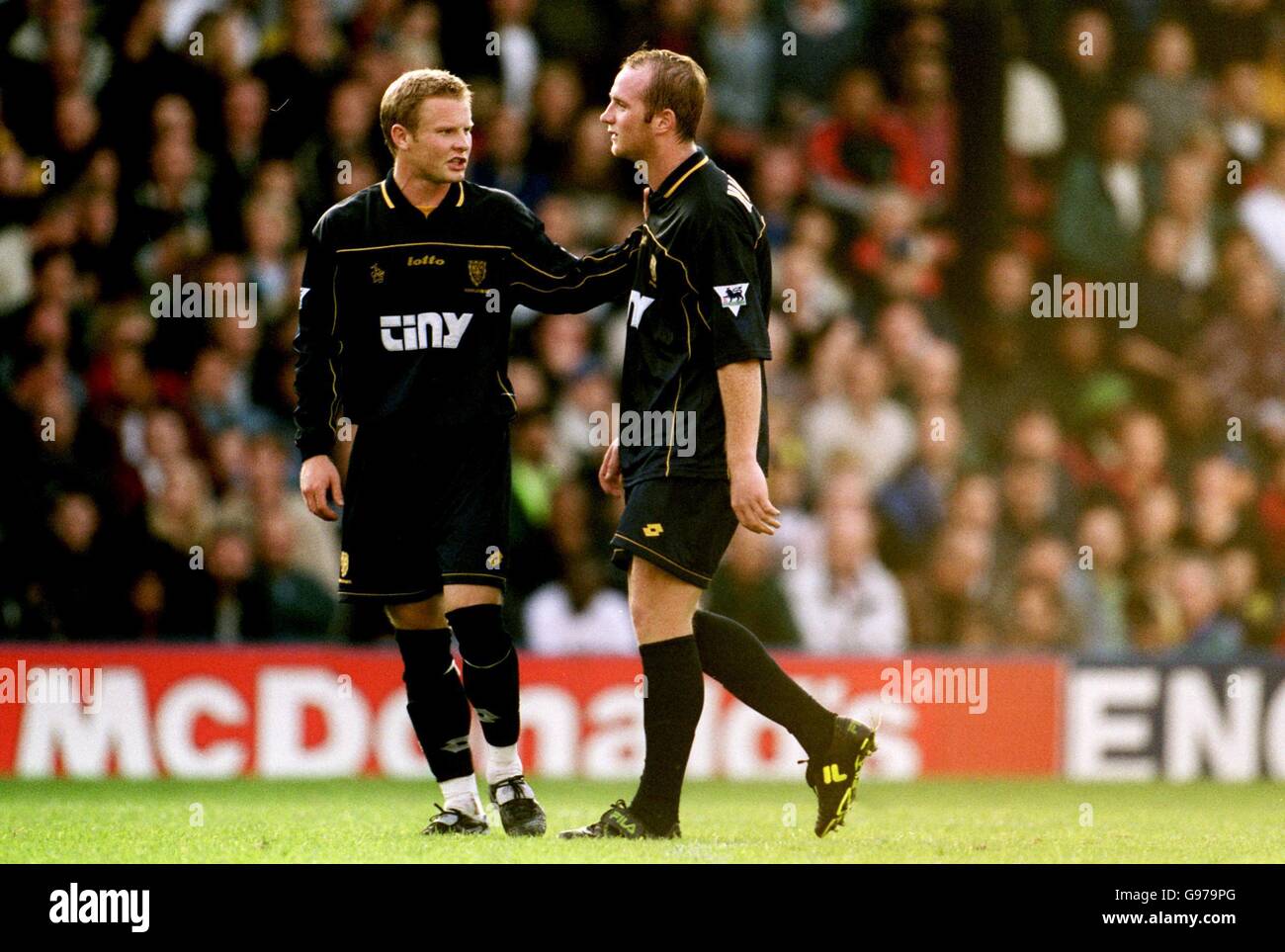 Wimbledon's John Hartson is consoled by Ben Thatcher after being sent ...