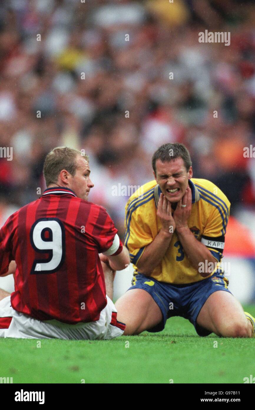 Sweden captain Patrik Andersson (right) holds his neck as England ...