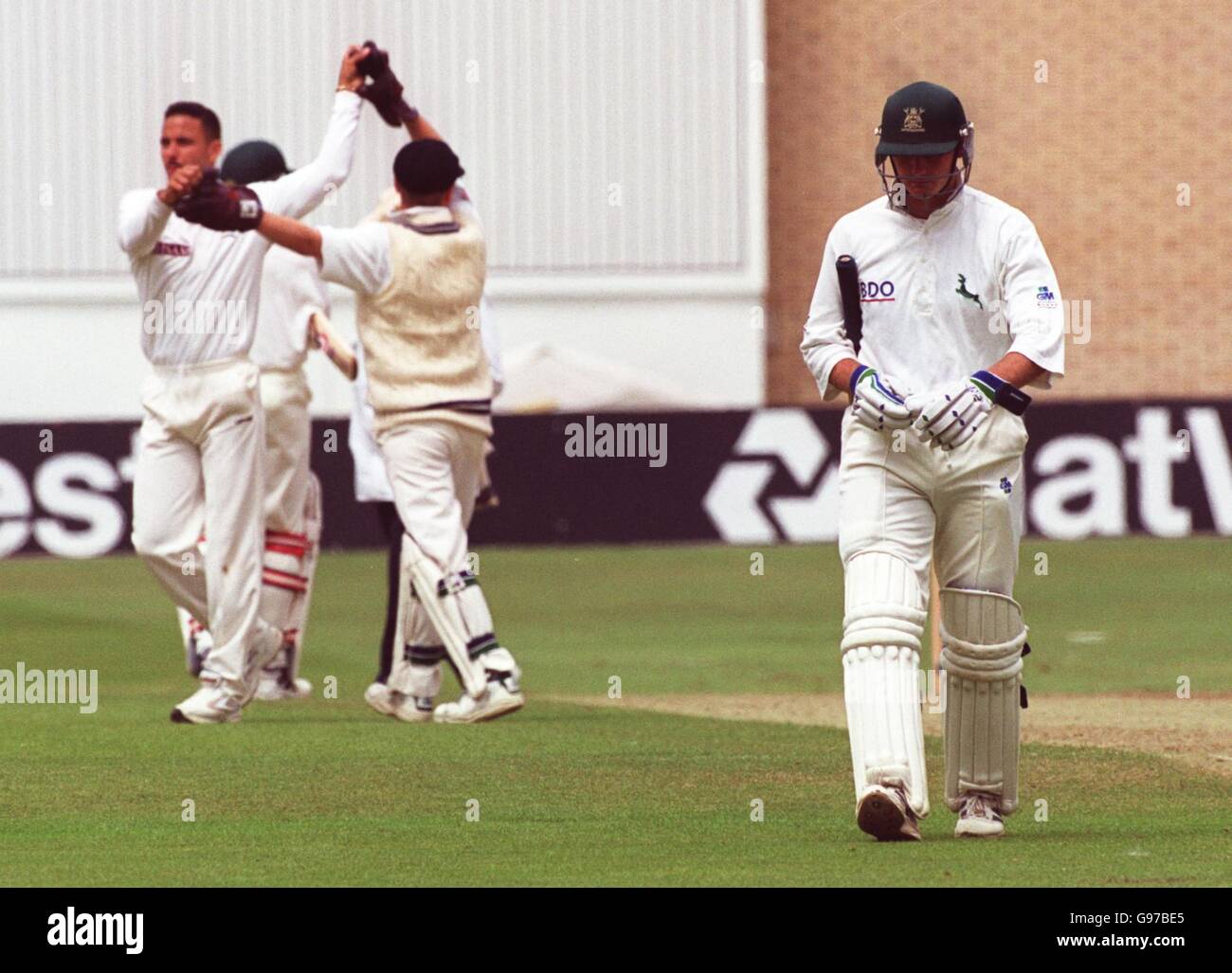 Nottinghamshire batsman Matthew Dowman walks as Middlesex celebrate the ...