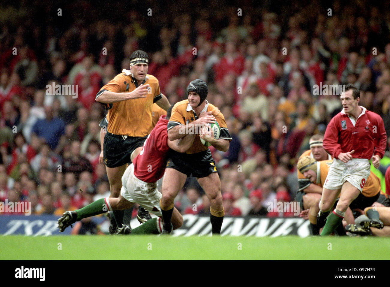 Australia's Ben Tune is tackled by Wales' Chris Wyatt. Australia ...