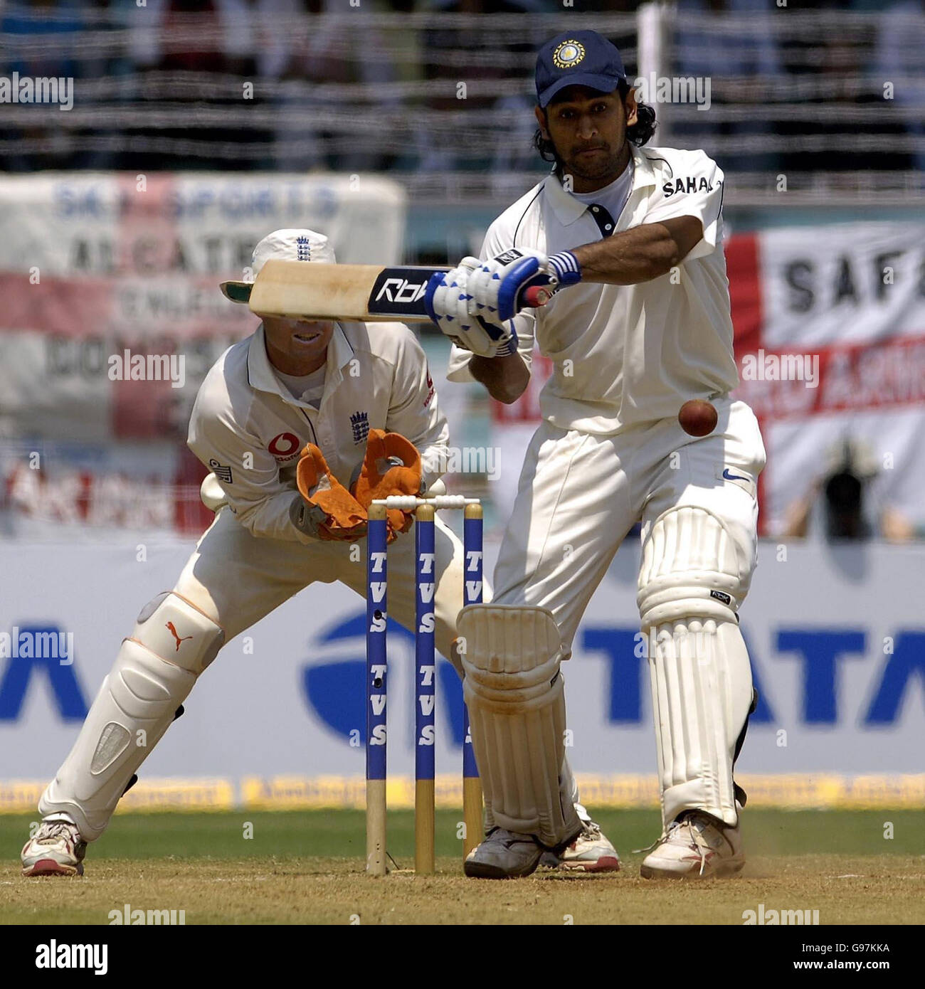 Indian batsman Mahendra Dhoni hits the ball for 4 runs against England ...
