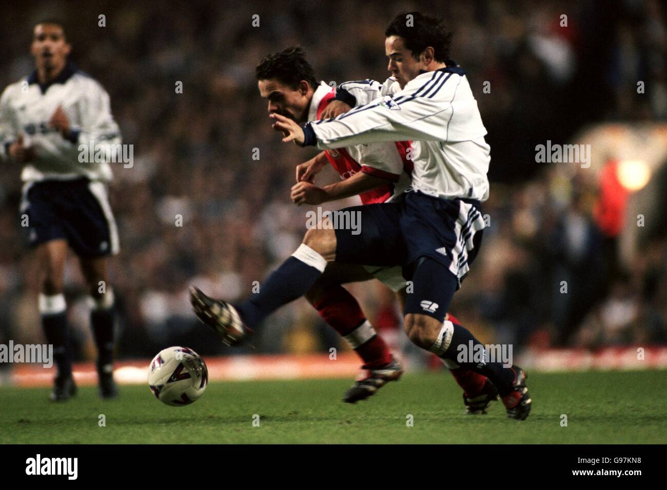 Tottenham Hotspur's Stephen Carr (right) tries to tackle Arsenal's Marc ...