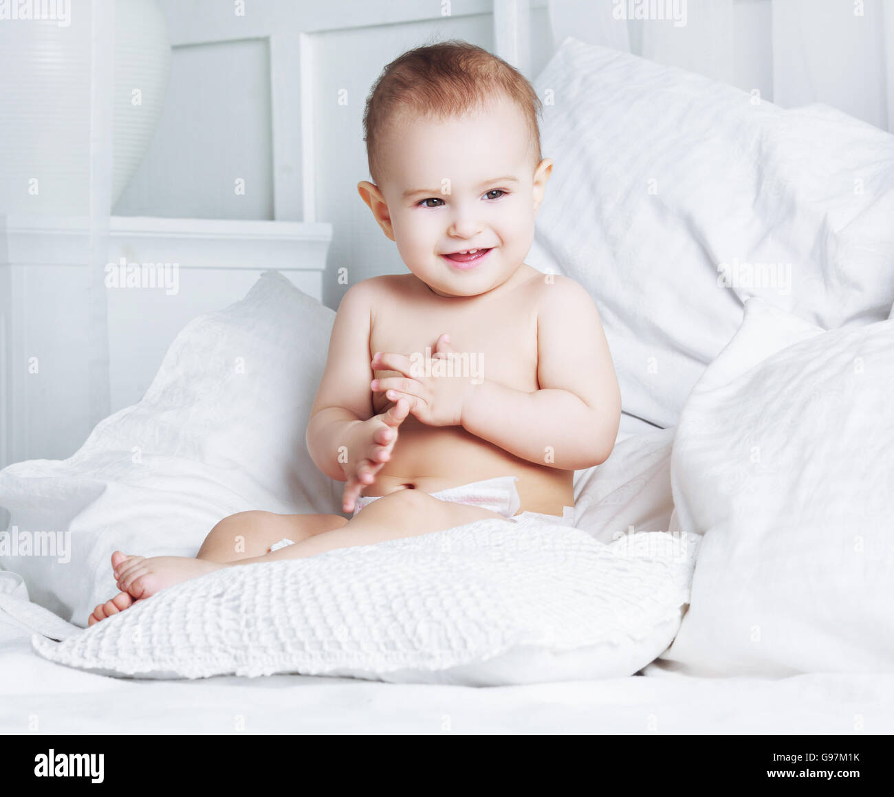 baby wearing diapers in bed at home Stock Photo - Alamy