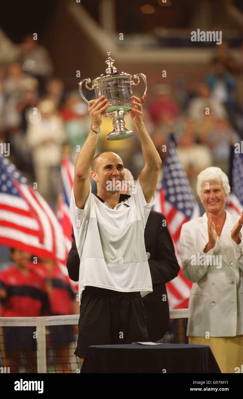 Andre agassi lifts us open mens singles trophy hi-res stock photography ...
