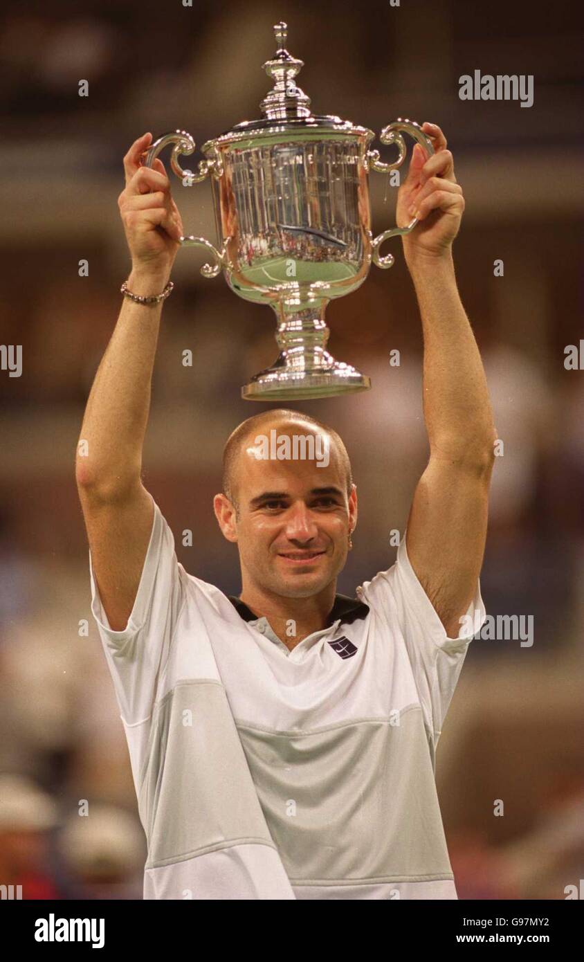Andre agassi lifts us open mens singles trophy hi-res stock photography ...