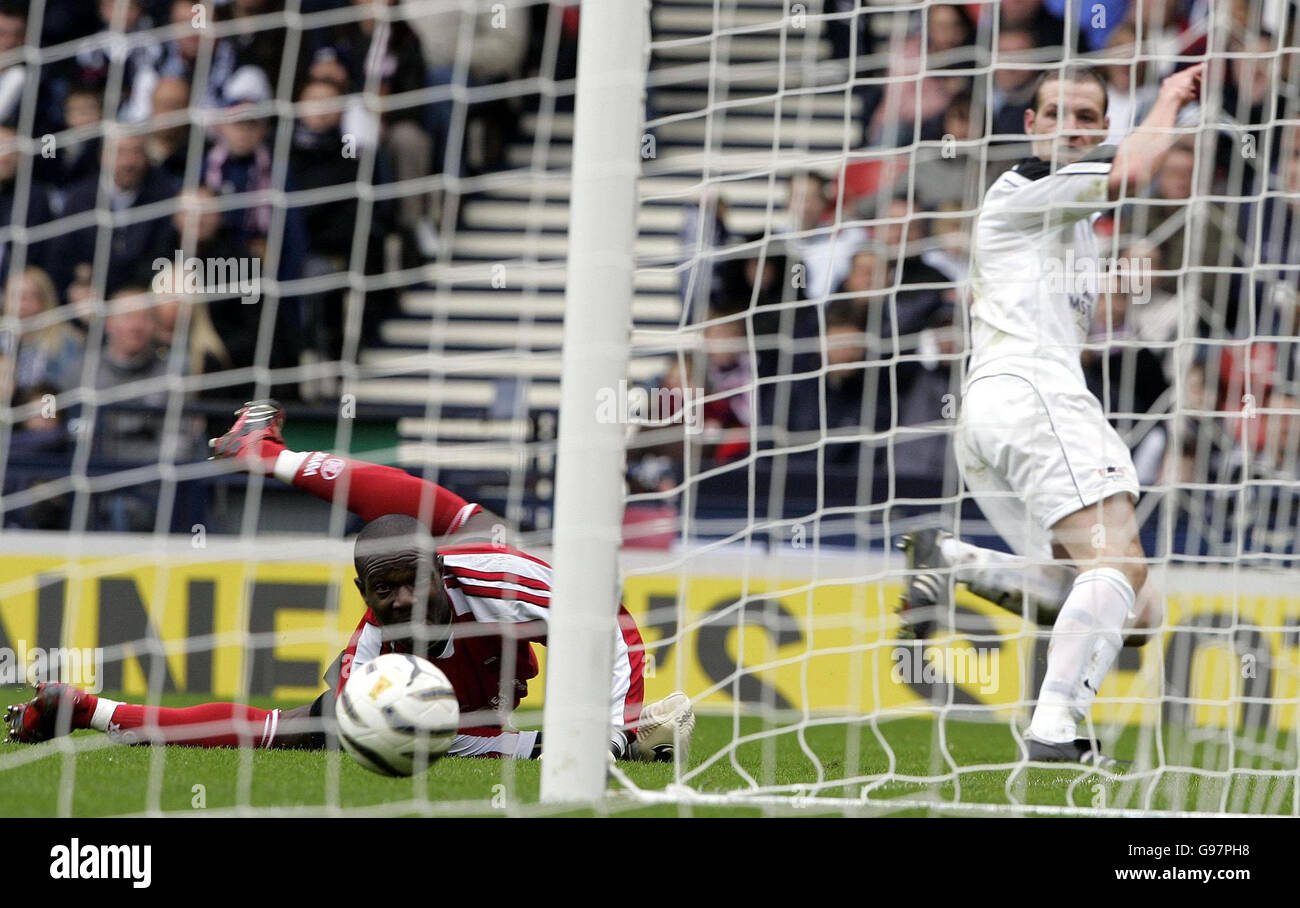 Dundee goalkeeper Kelvin Jack can only watch as the ball crosses the ...