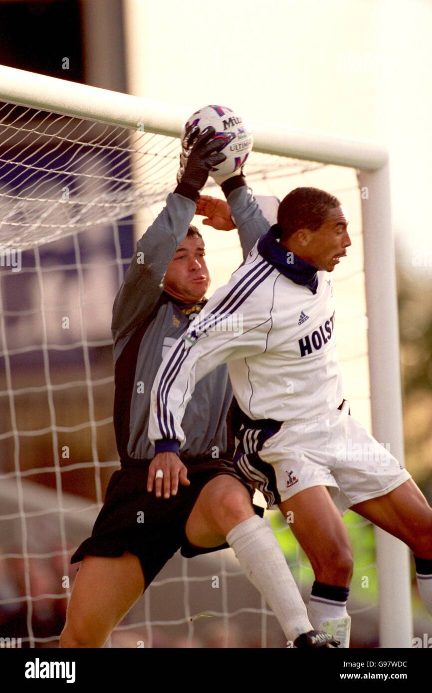 Wimbledon goalkeeper Neil Sullivan (left) claims a cross under pressure ...