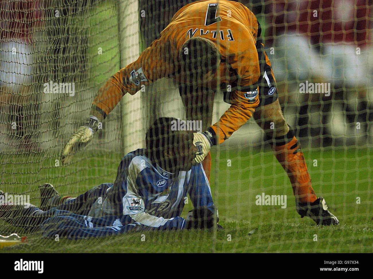 Wigan Athletic's Pascal Chimbonda is consoled by keeper John Filan ...