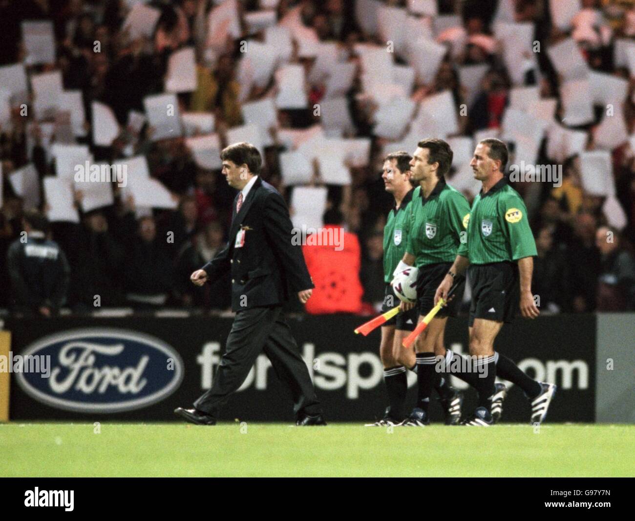 The referee's & assistant referee's walk out for the start of the match ...