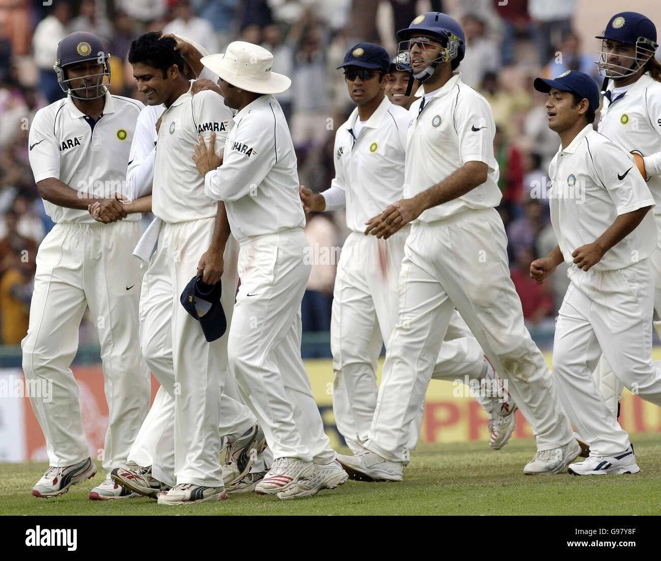 Indian spin bowler Anil Kumble (2nd left) is led off the field after ...