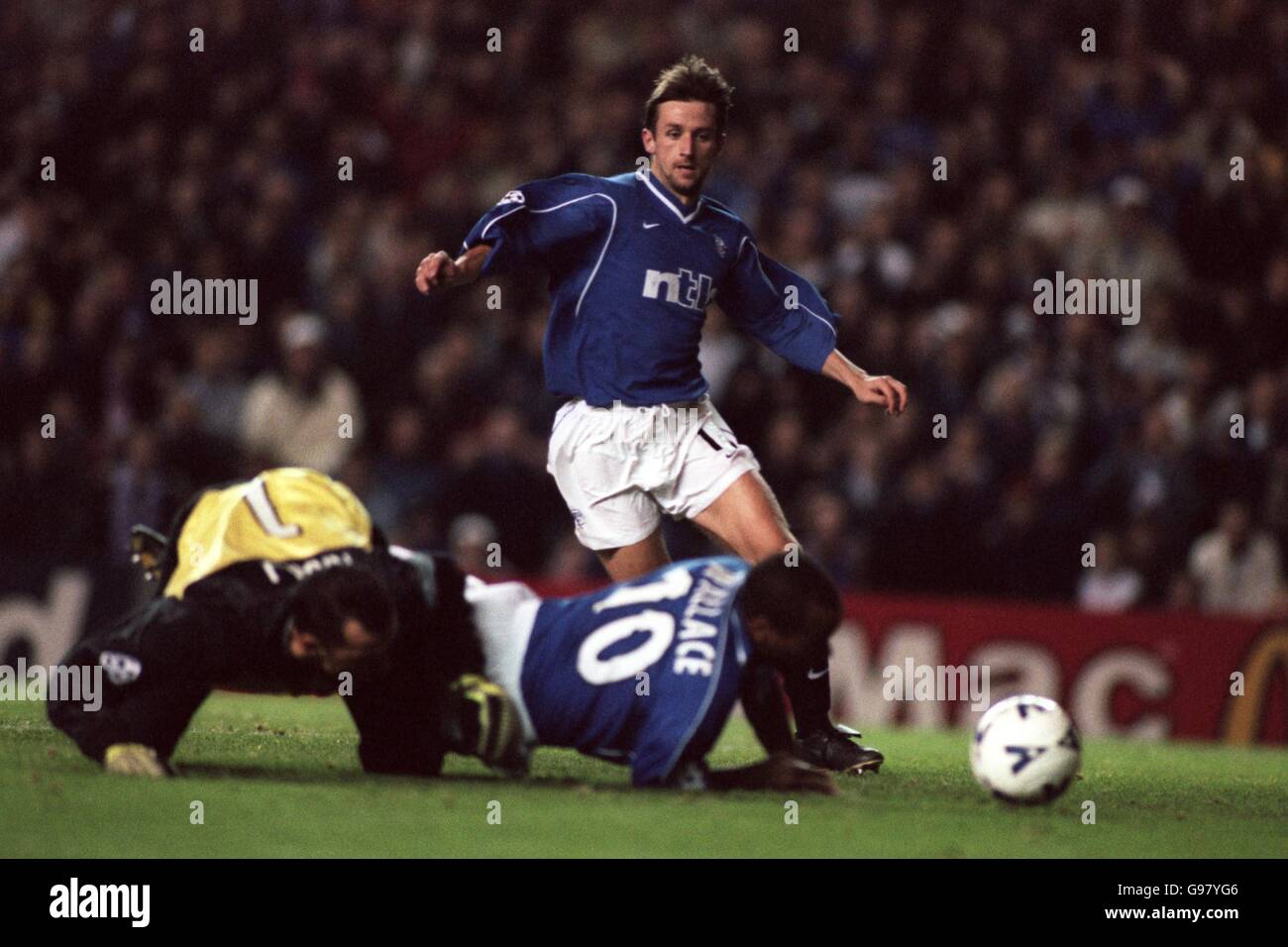 Rangers' Neil McCann and Rod Wallace (floored) and PSV's Ivica Kralj ...
