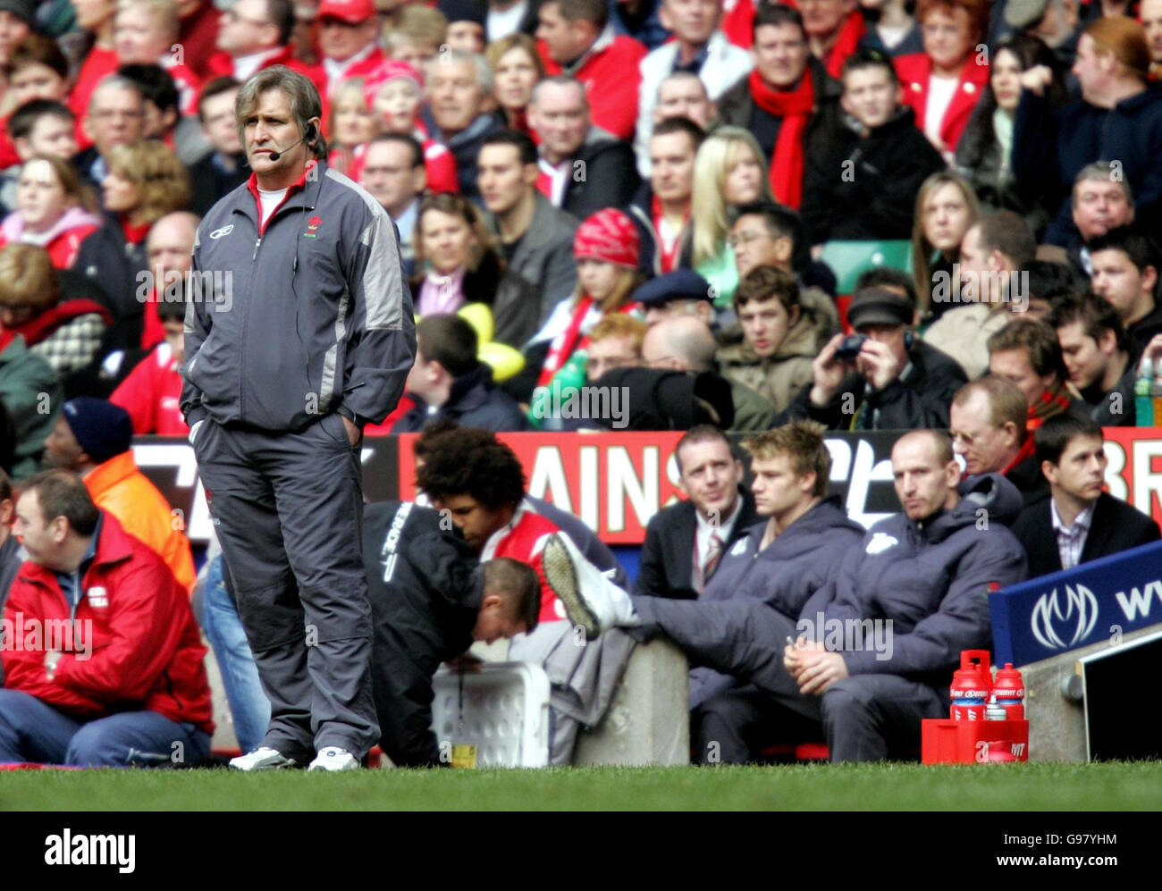 Wales caretaker coach Scott Johnson (L) looks on from the touchline ...