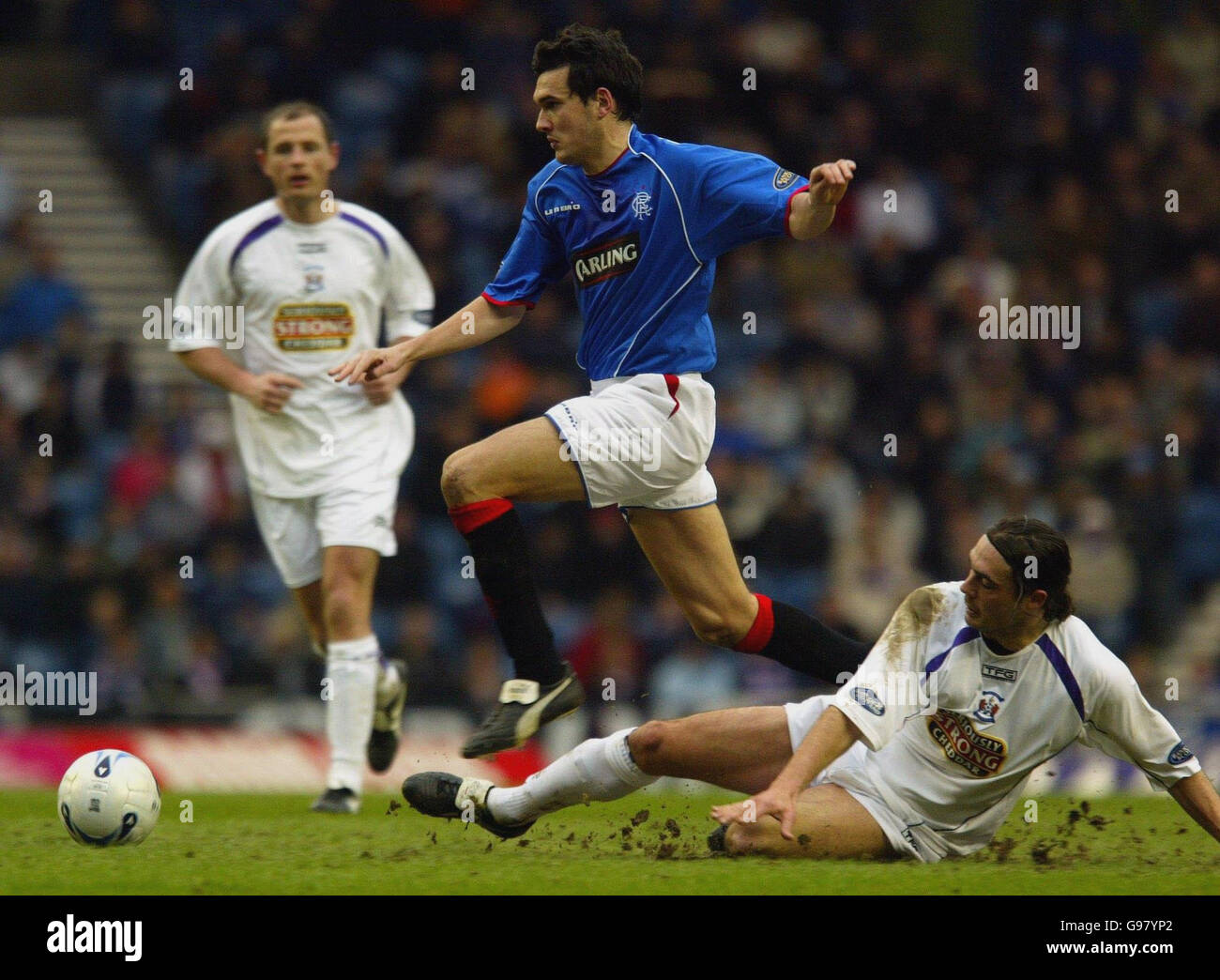 Rangers' Ian Murray (C) holds off Kilmarnock's Danny Invincible during ...
