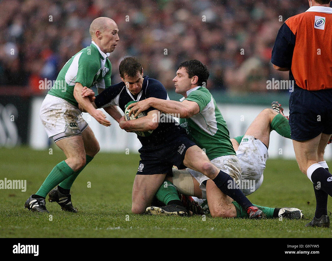 Ireland's Peter Stringer tackles Scotland's Chris Paterson (C) during the RBS 6 Nations match at ...