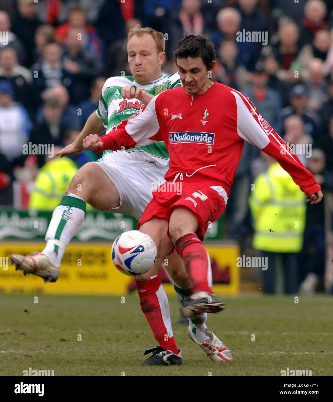 Yeovil's Paul Terry (L) battles with Swindon Town's Gareth Whalley ...