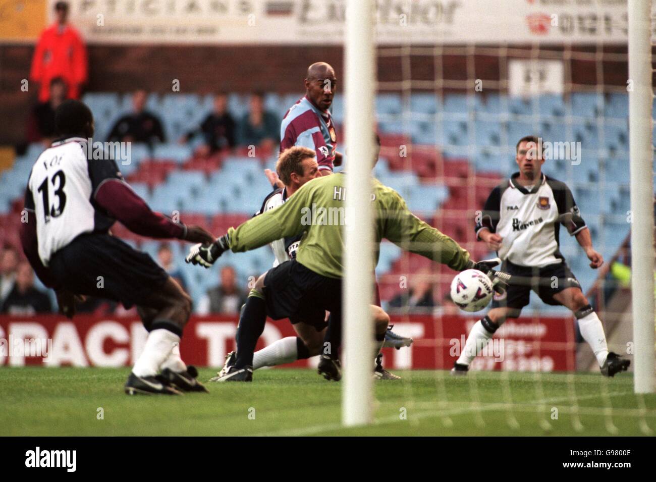 Aston Villa's Dion Dublin squeezes the ball past West Ham United's ...