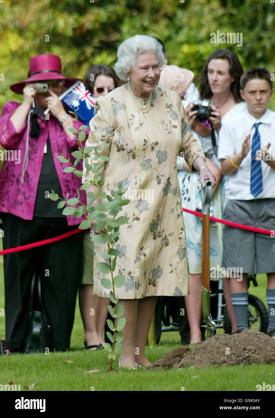 Queen Elizabeth II plants a eucalyptus tree during a visit to ...