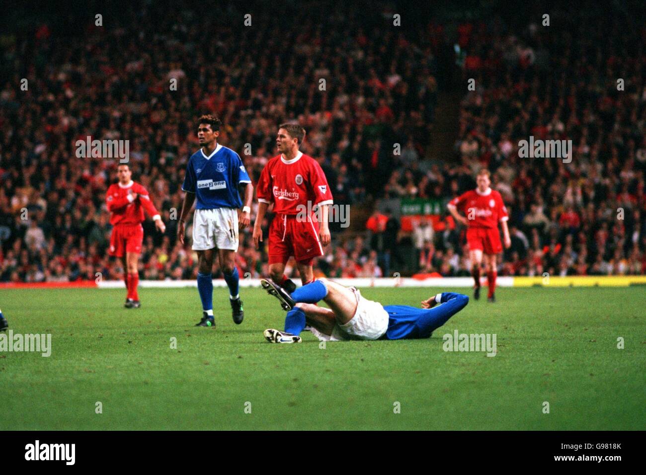 Everton's David Weir (on floor) lies injured after being fouled by ...