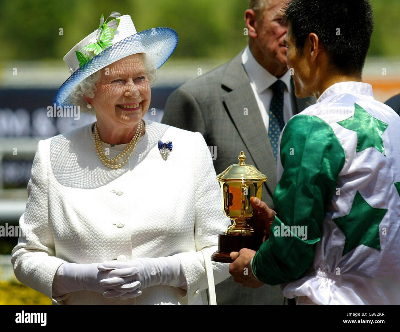 Britain's Queen Elizabeth II speaks with the winning jockey after ...