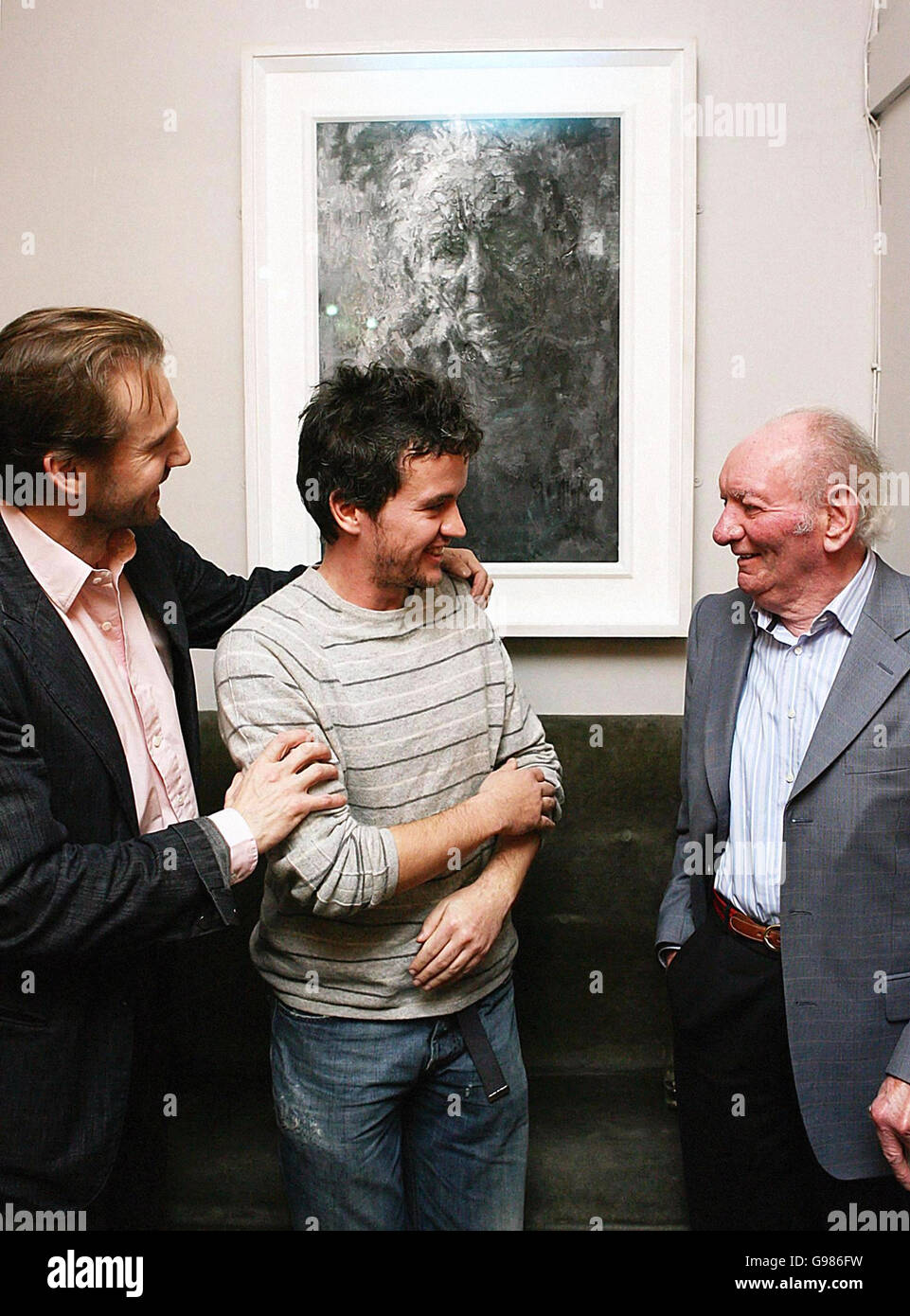 Actor Ralph Fiennes (left) congratulates artist Cian McLoughlin (centre ...