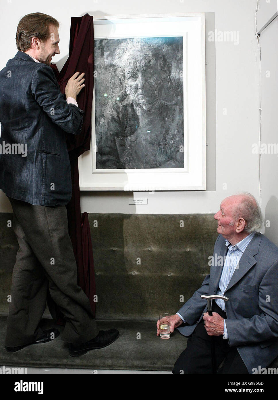 Irish playwrite Brian Friel sits beneath a portrait of himself painted ...