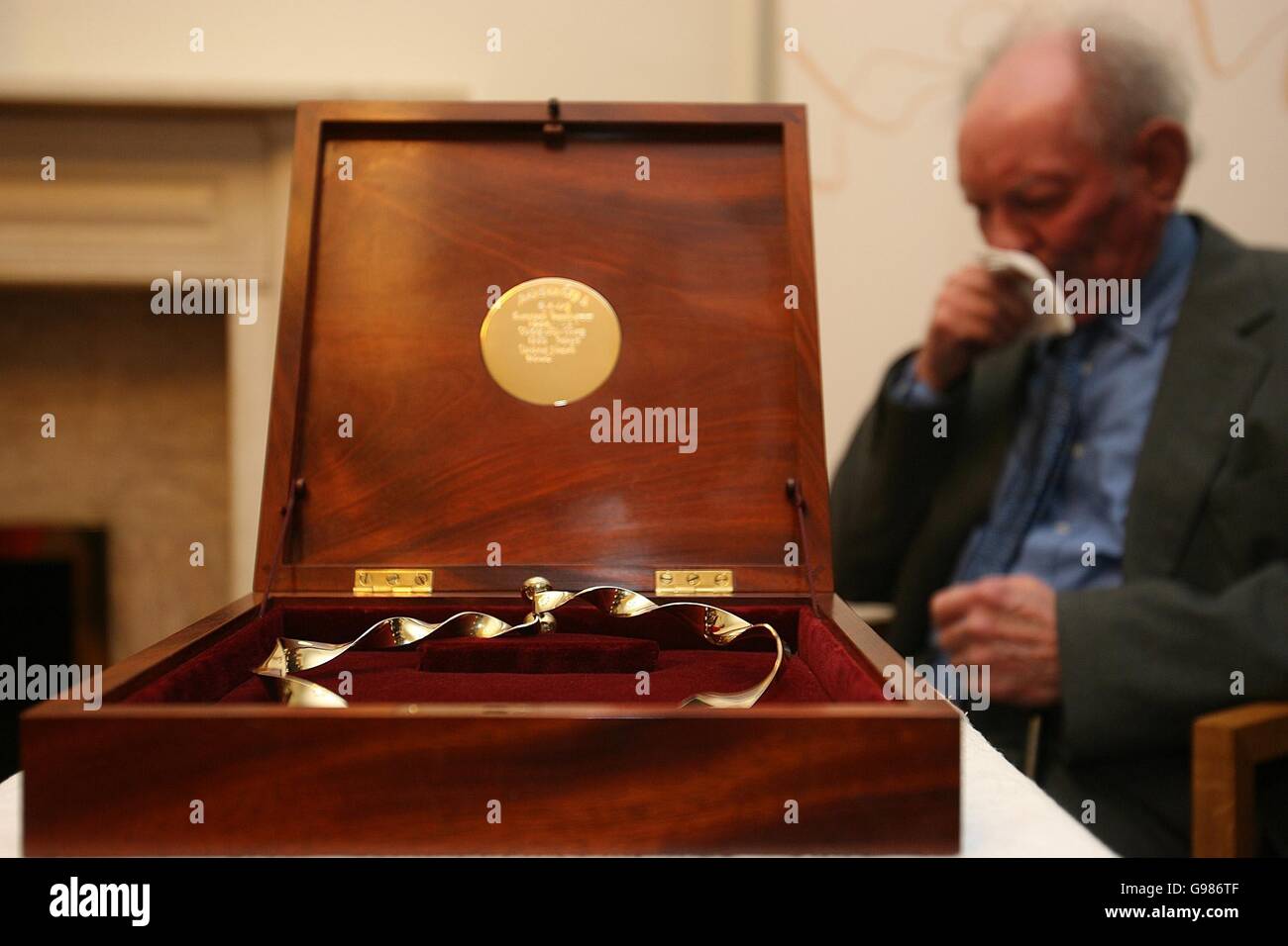 Playwright Brian Friel looks at the Golden Torc he received in ...
