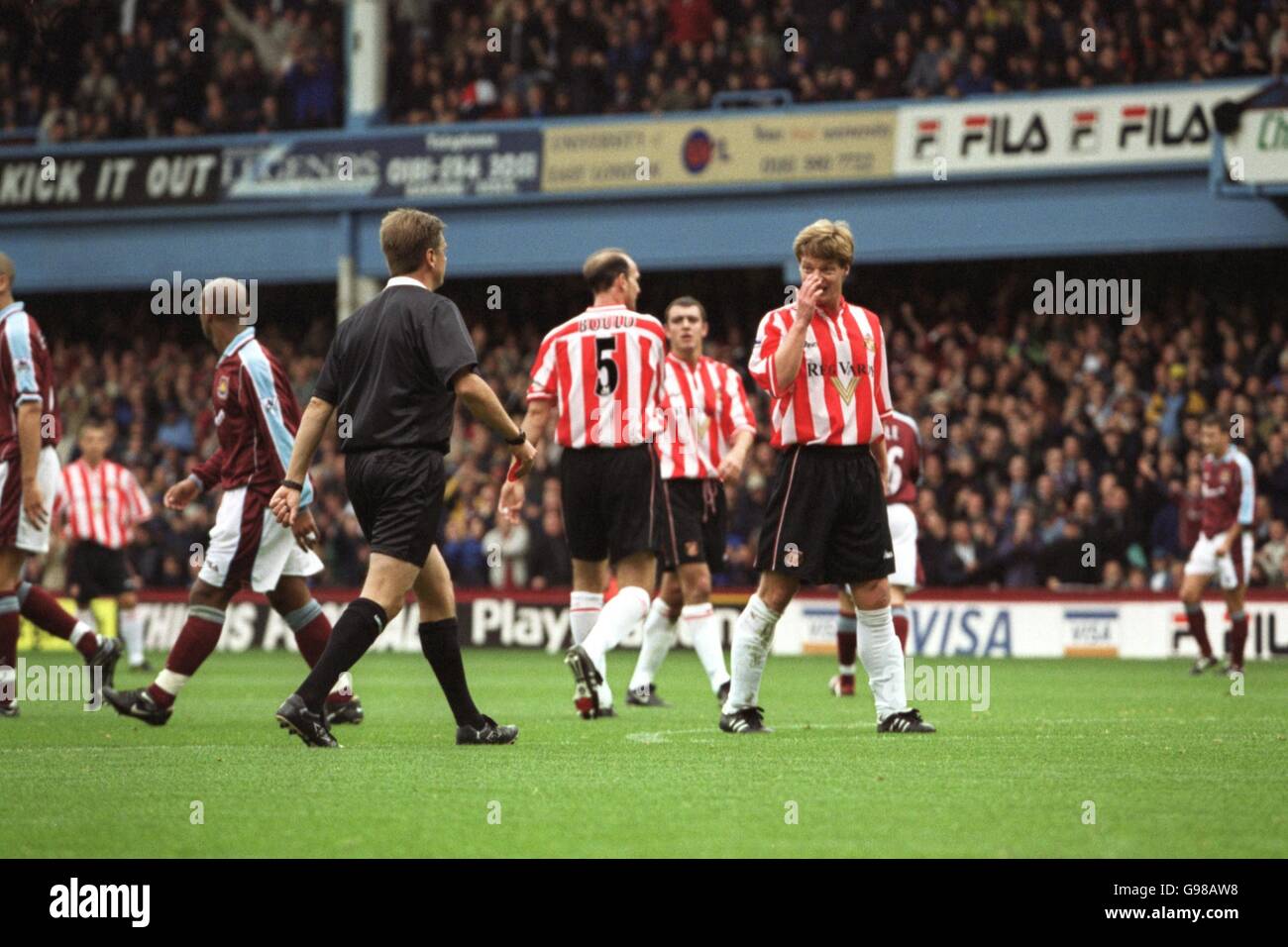 Referee Mark Halsey puts away the red card after sending off Sunderland ...