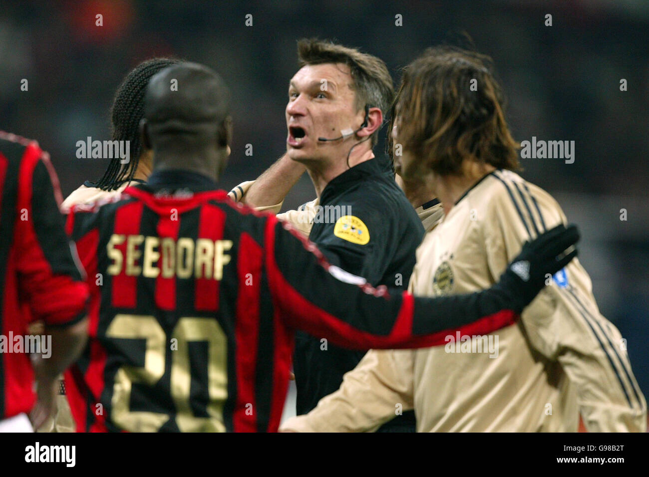 Referee Valentin Ivanov tries to control the AC Milan and Bayern Munich ...