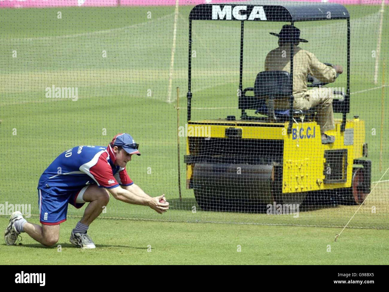 England's Andrew Strauss takes a slip catch as a groundsman rolls the ...