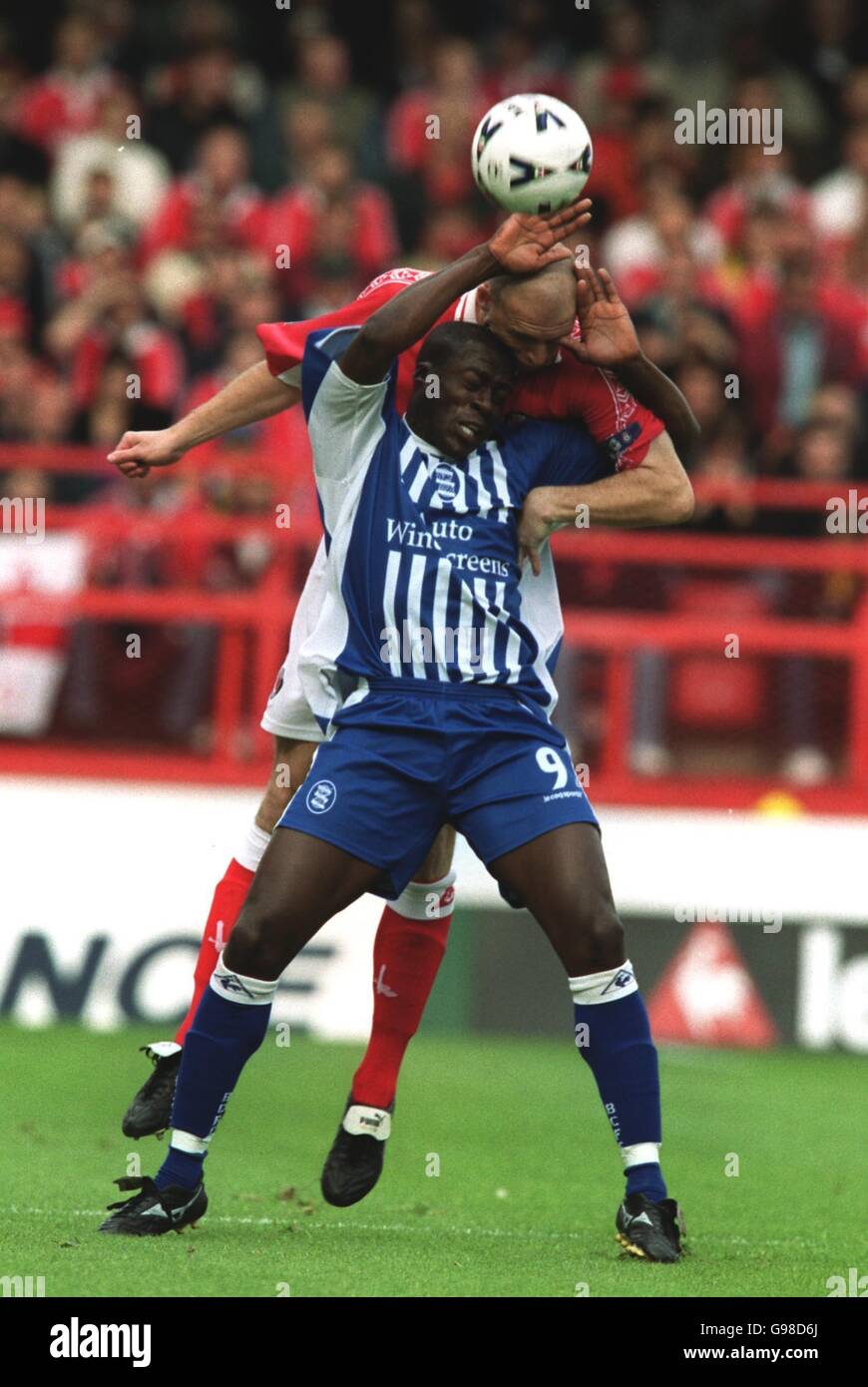 Charlton Athletic's Eddie Youds (back) heads clear from Birmingham City ...
