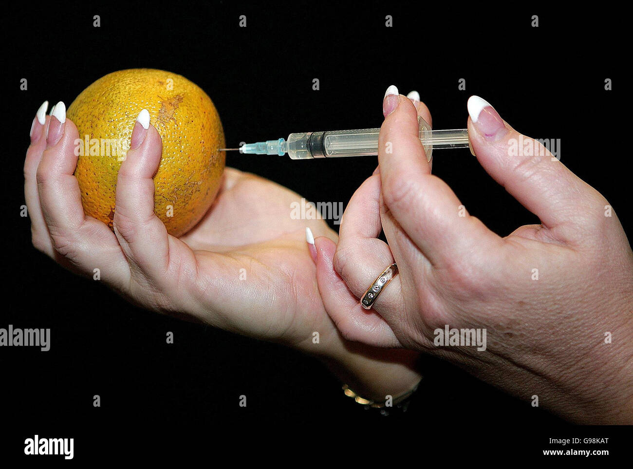 A nurse injects an orange during a mass immunisation exercise at Bolton ...