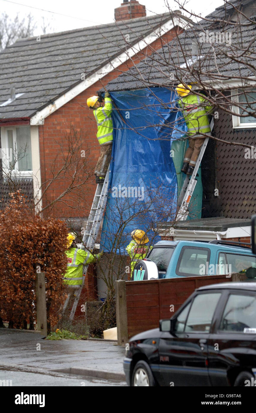 Emergency service personnel at the house Friday March 10, 2006, in ...