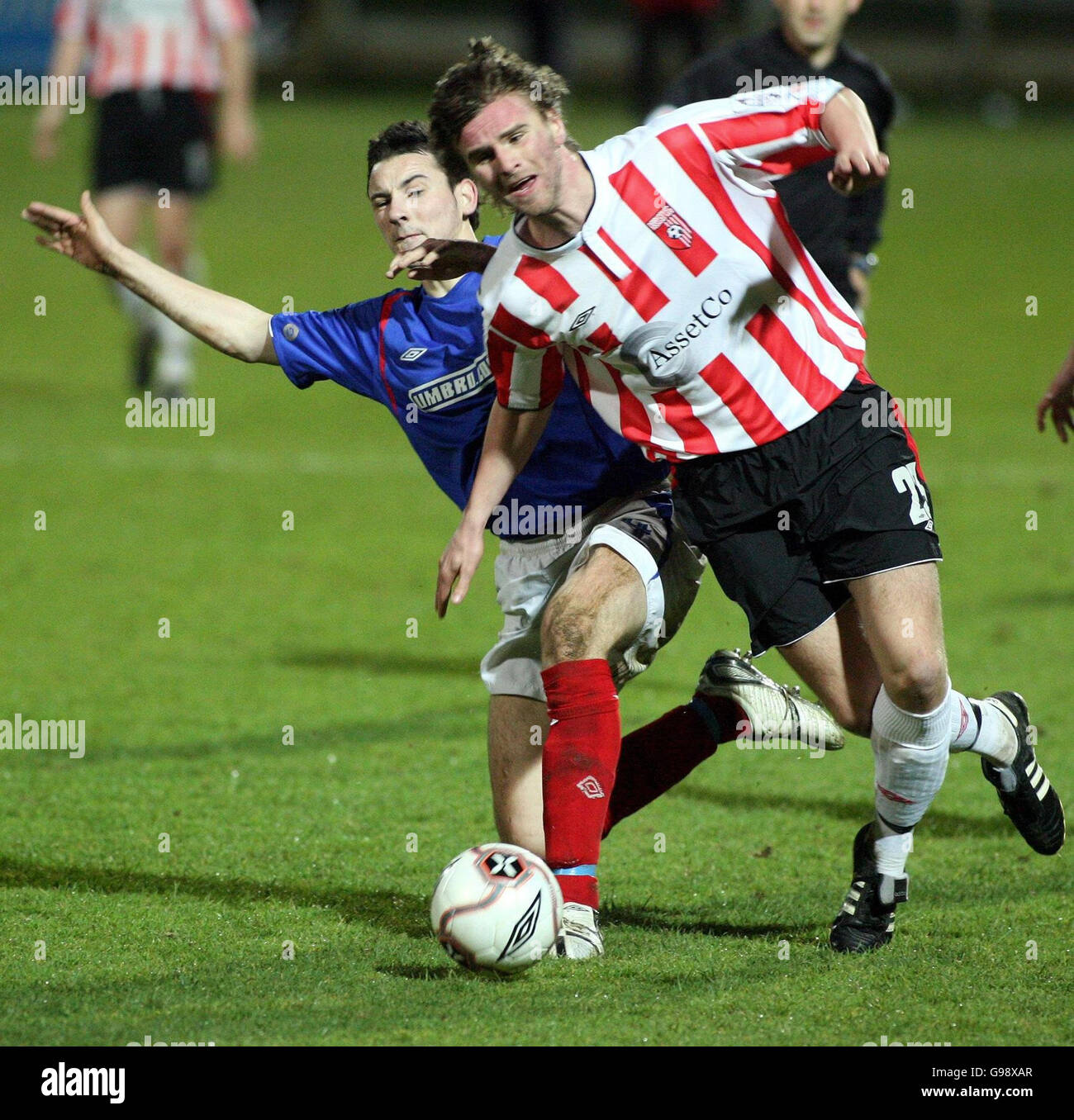 Linfield's Michael Gault (L) tangles with Derry City's Partrick McCourt ...