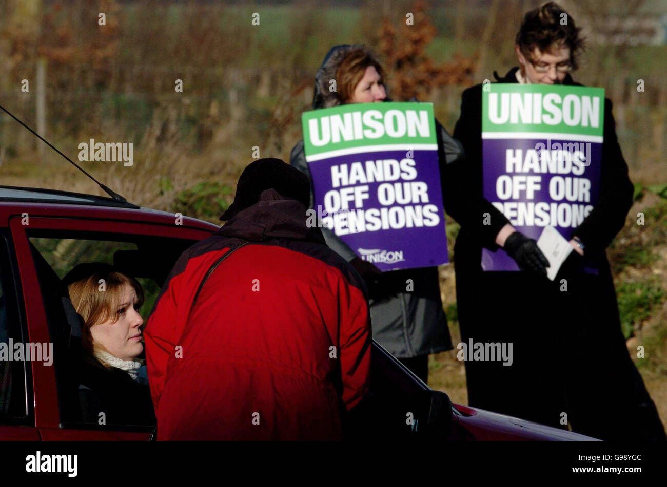 A local authority worker talks to a colleague before she crosses the ...