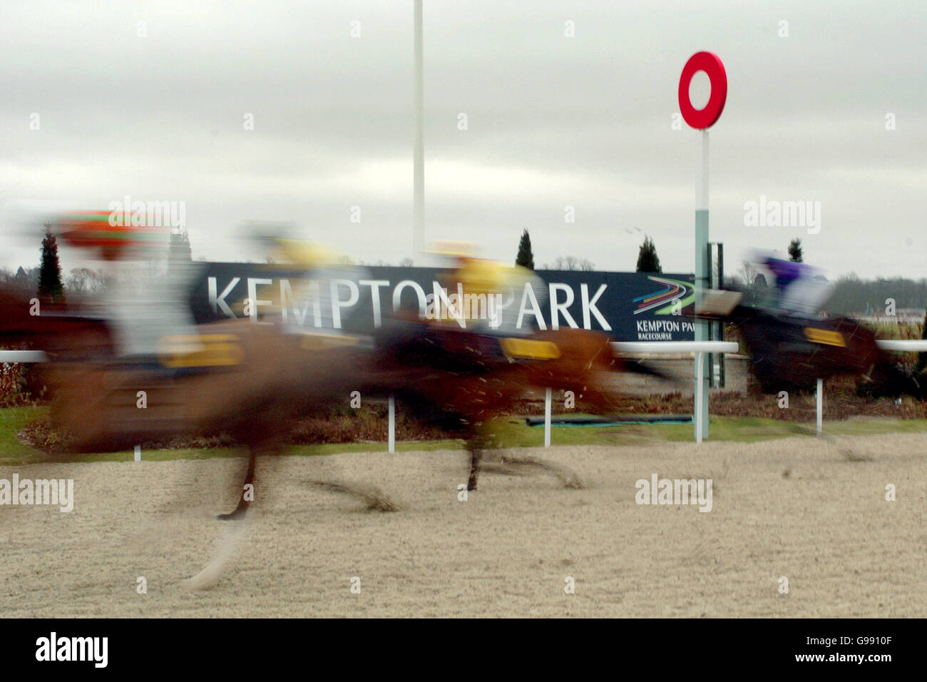 Horses flash past the finishing post at kempton park hi-res stock ...
